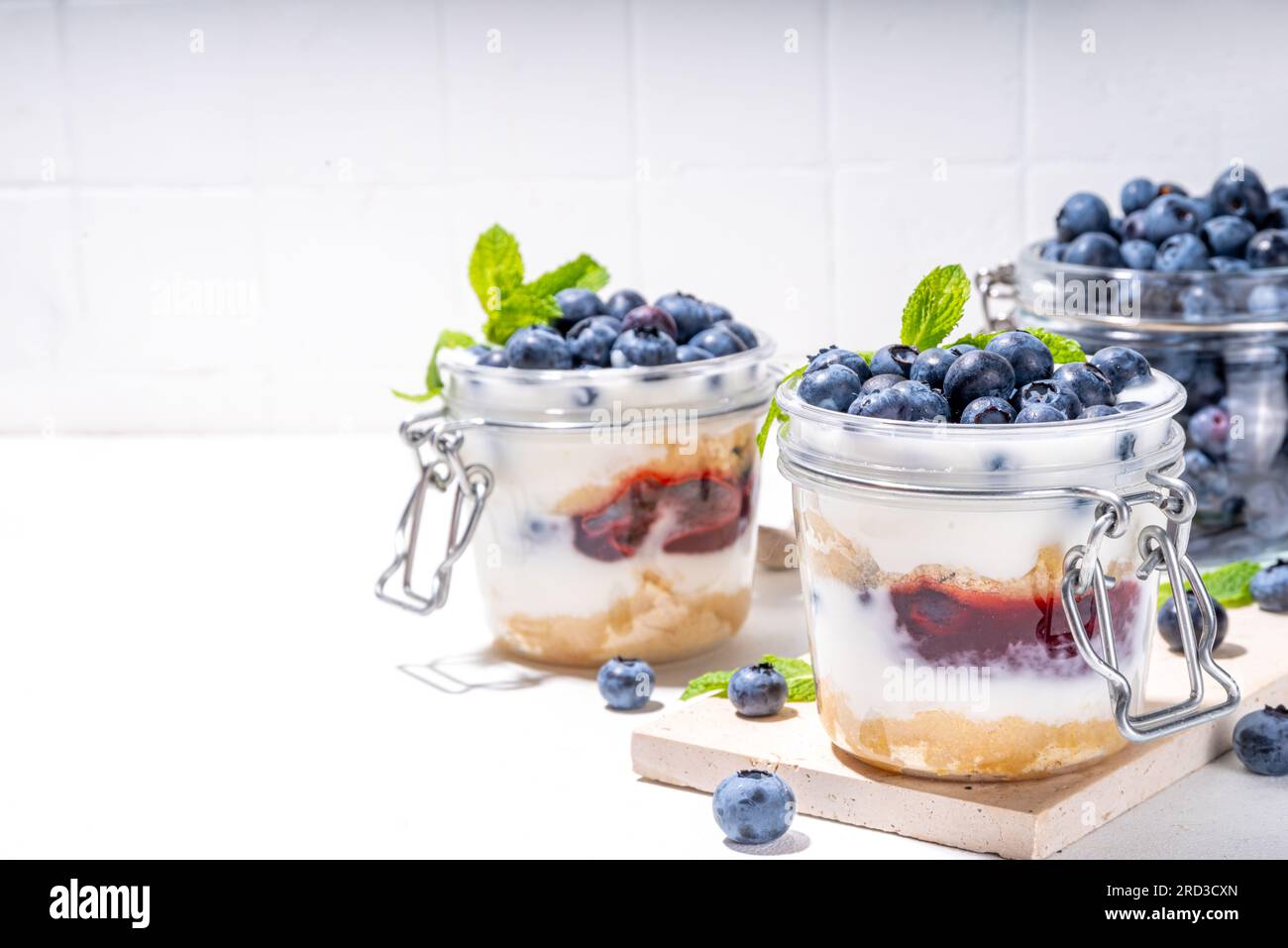 Layered blueberry parfait dessert, cheesecake in glass with vanilla ...