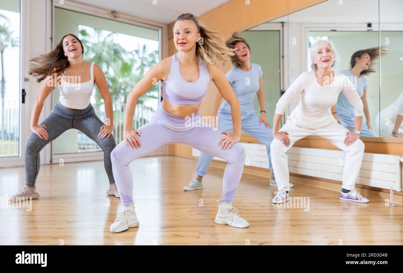 Women learning modern dance movements at class together Stock Photo - Alamy