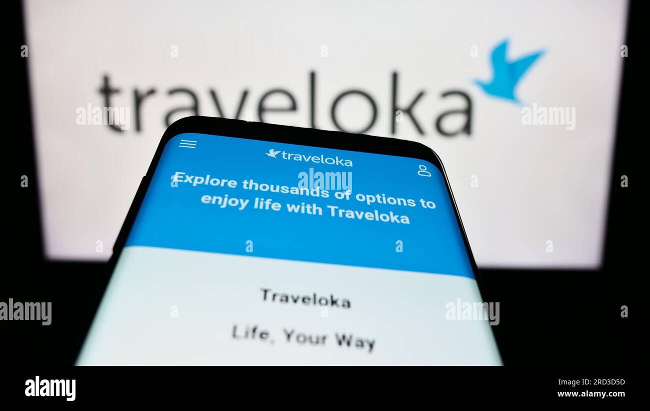 Mobile phone with website of Indonesian travel company Traveloka on ...