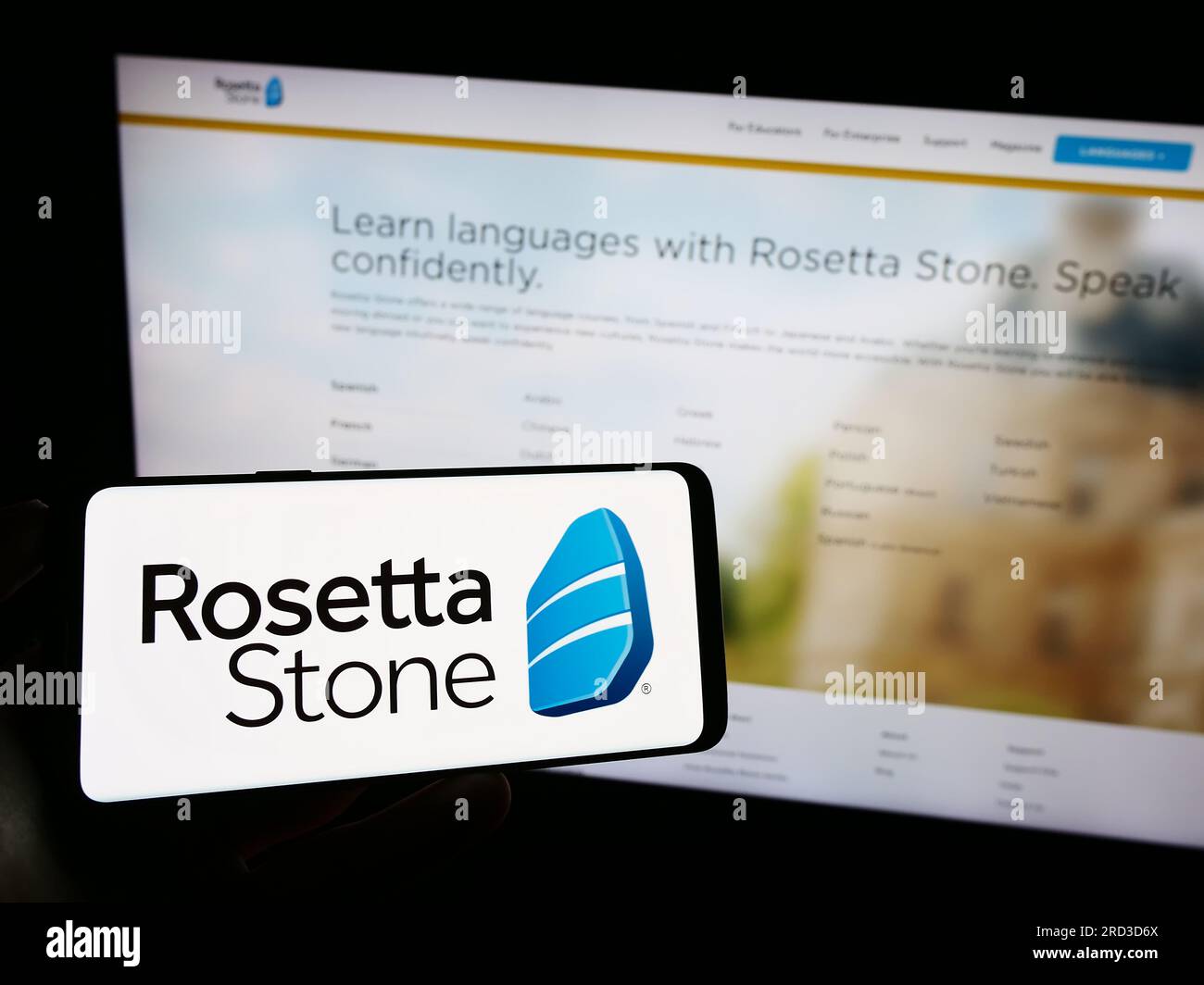 Person holding cellphone with logo of US education technology company Rosetta Stone Inc. on ...
