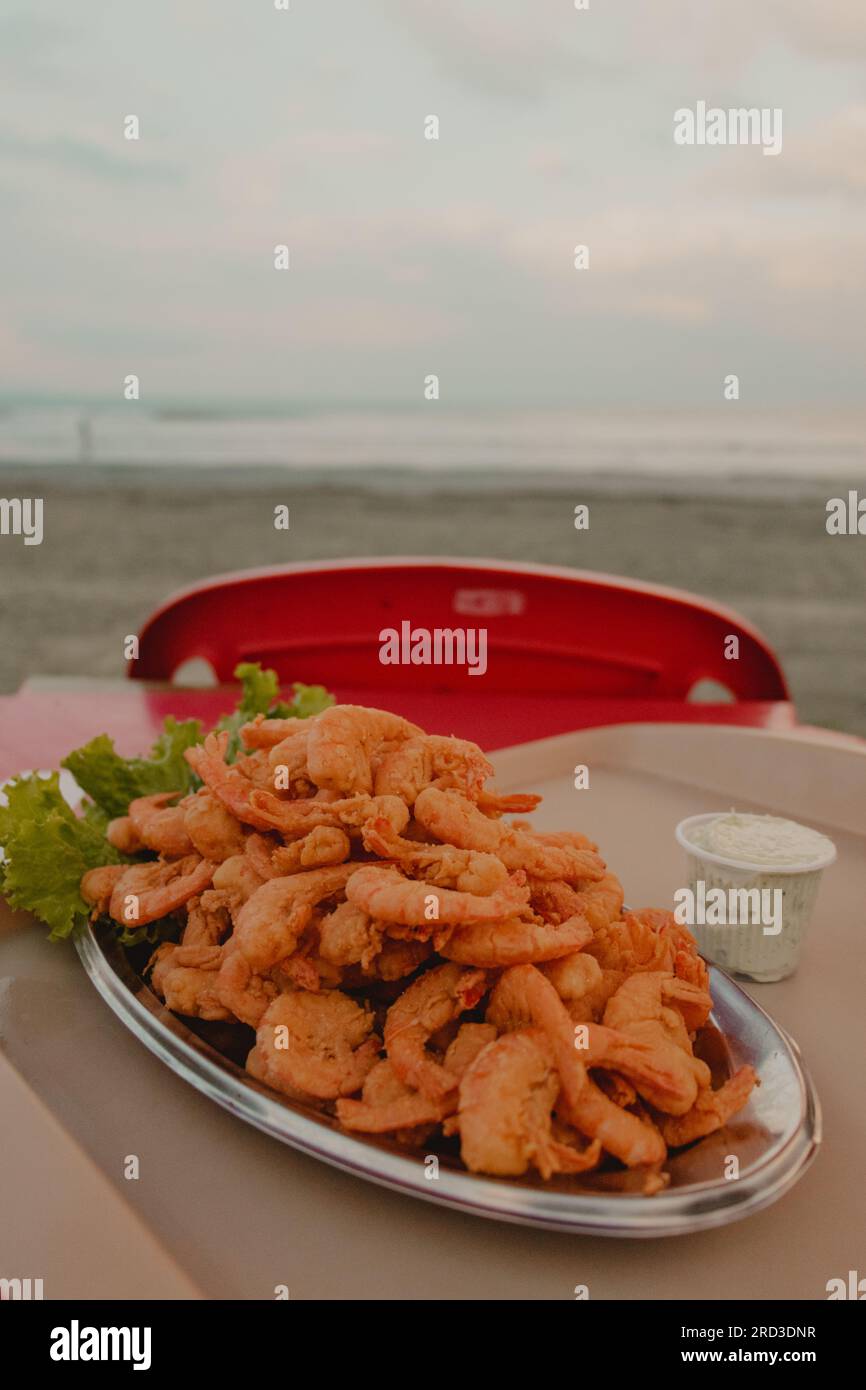 eating fried shrimp at the beach Stock Photo - Alamy