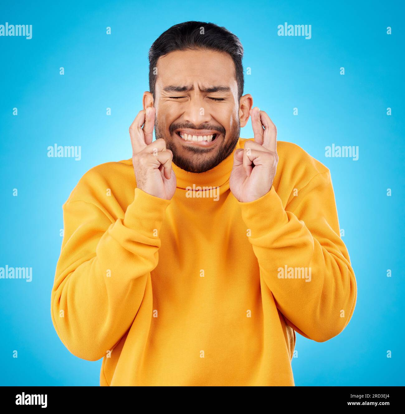 Nervous, eyes closed and fingers crossed by asian man with anxiety in ...