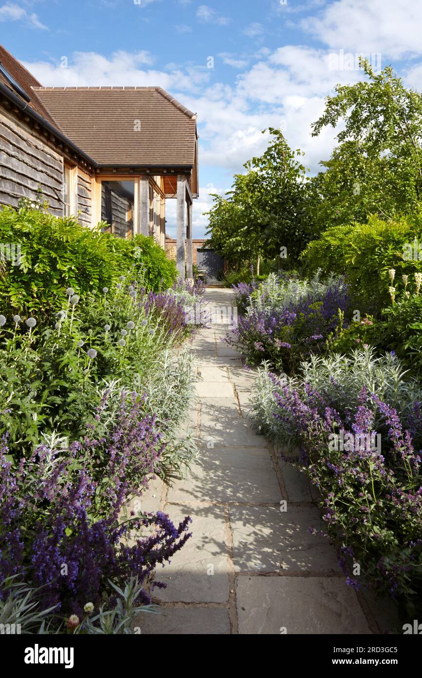 Path leading to front entrance with flower border each side. Manor Barn ...
