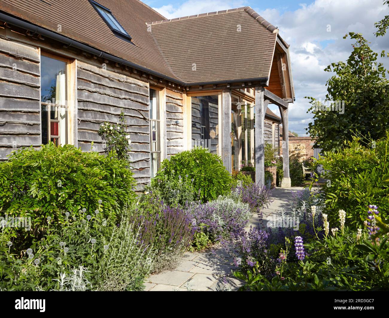 Path leading to front entrance with flower border each side. Manor Barn ...