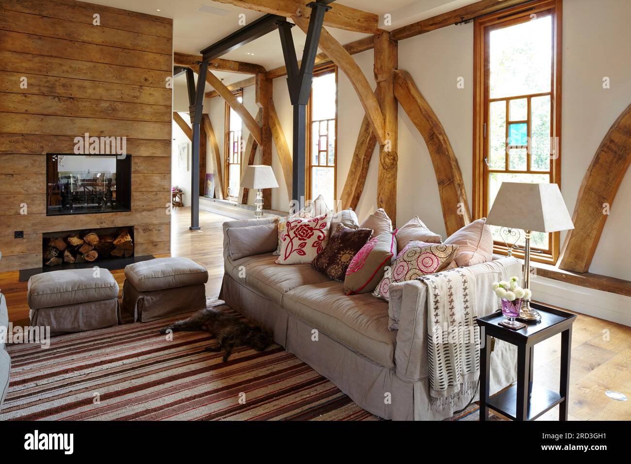 Barn conversion interior timer frame & beams. Wood floor and furniture ...