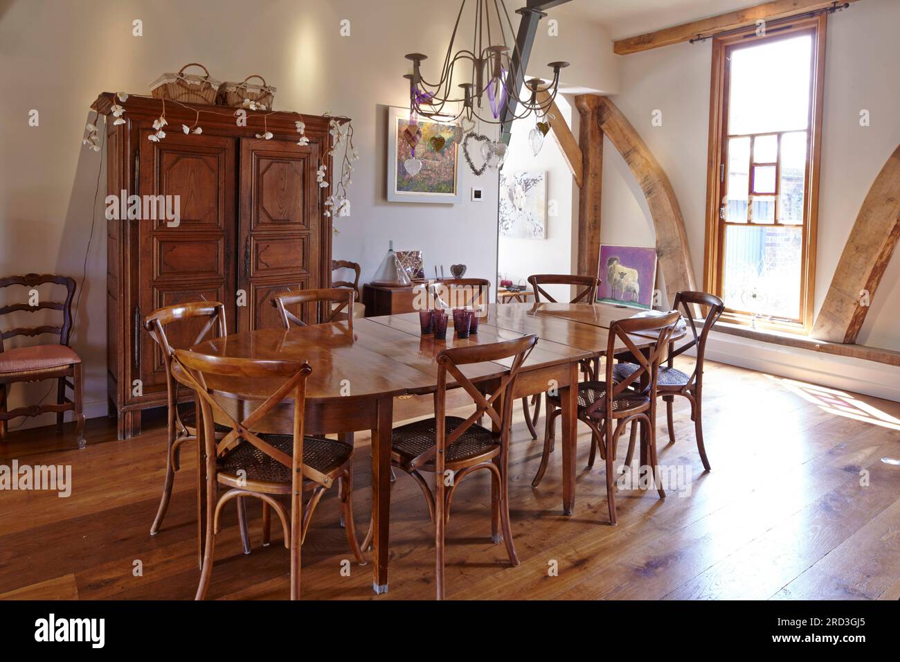 Barn conversion interior timer frame & beams. Wood floor dinning area w ...