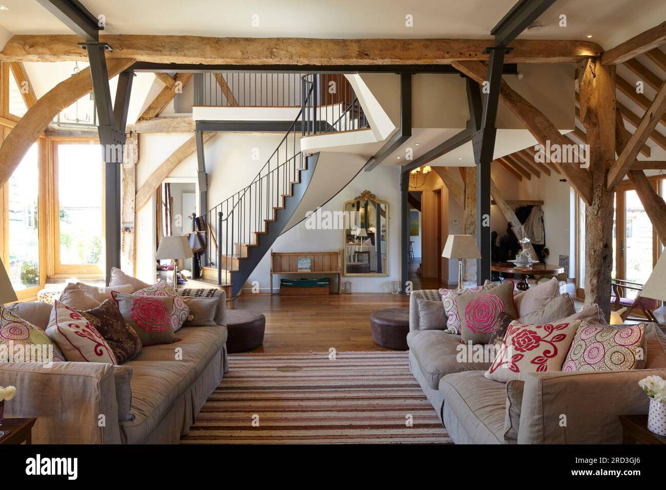 Barn conversion interior timer frame & beams. Wood floor and furniture ...