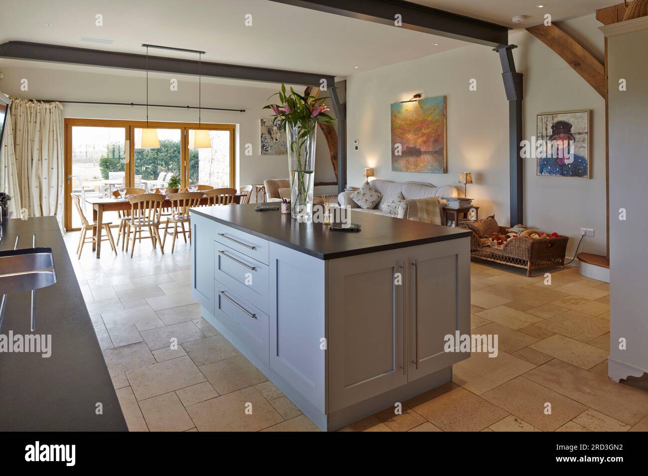 Kitchen area with central island, cabinets, cooking area, and windows ...