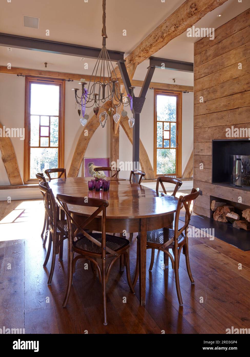 Barn conversion interior timer frame & beams. Wood floor dinning area w ...