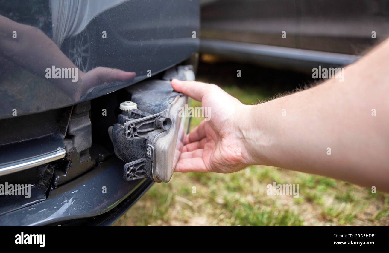 Disassembling and removing the fog lamp from a car to replace a burnt ...