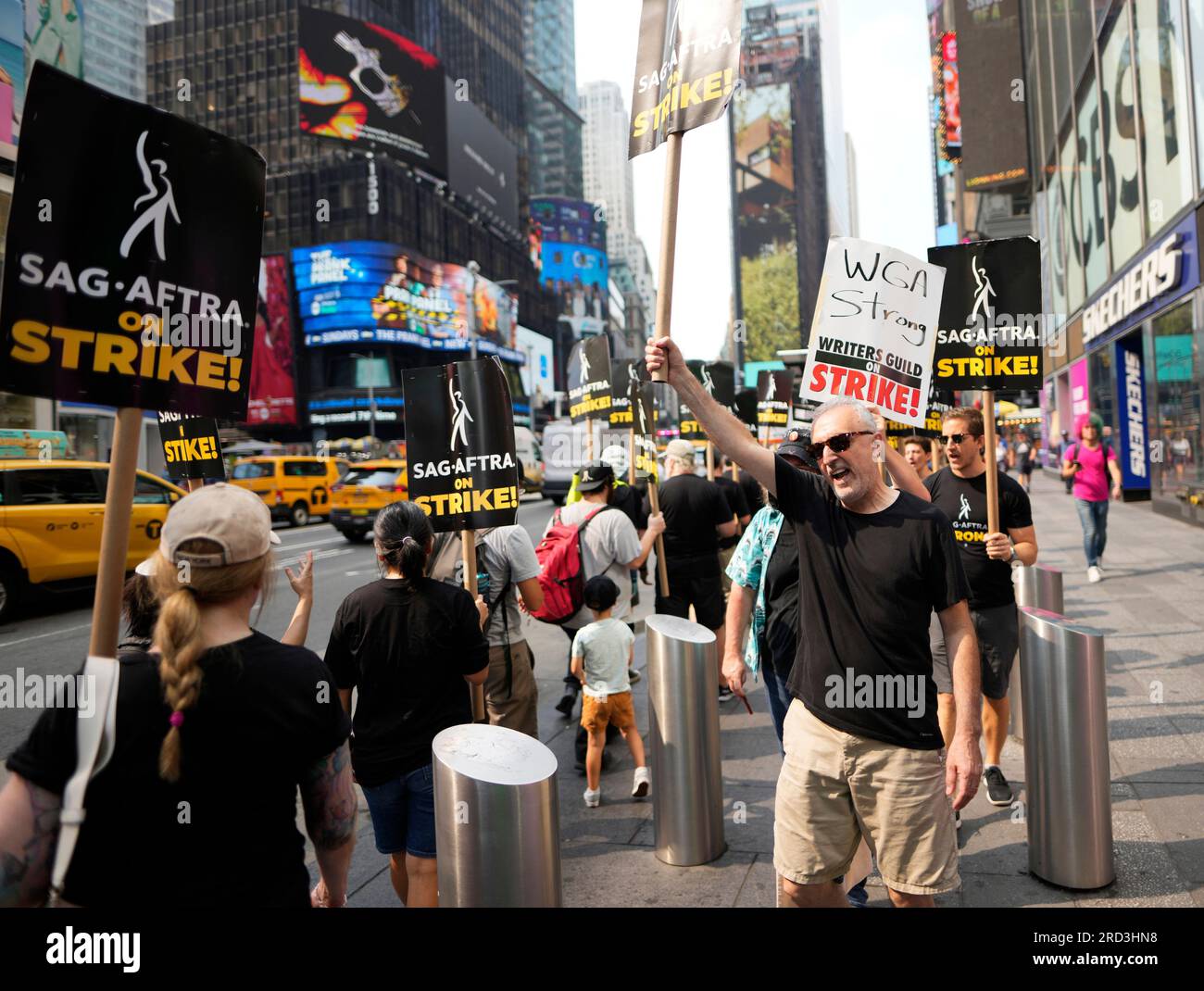 Picketers carry signs outside Paramount in Times Square on Tuesday ...