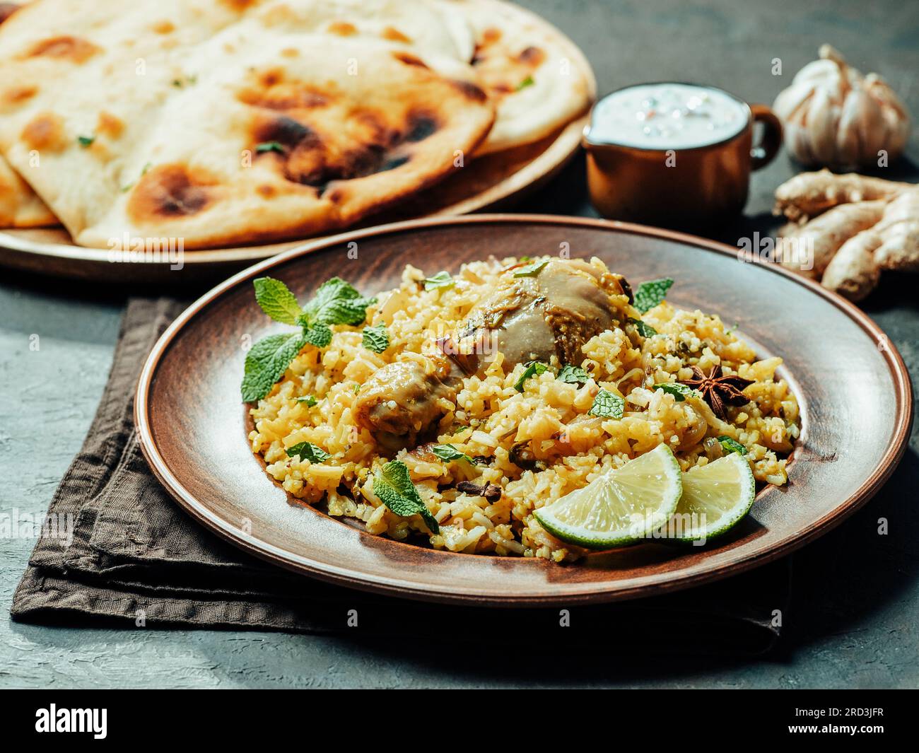 Pakistani food - biryani rice with chicken, raita yoghurt dip and naan ...