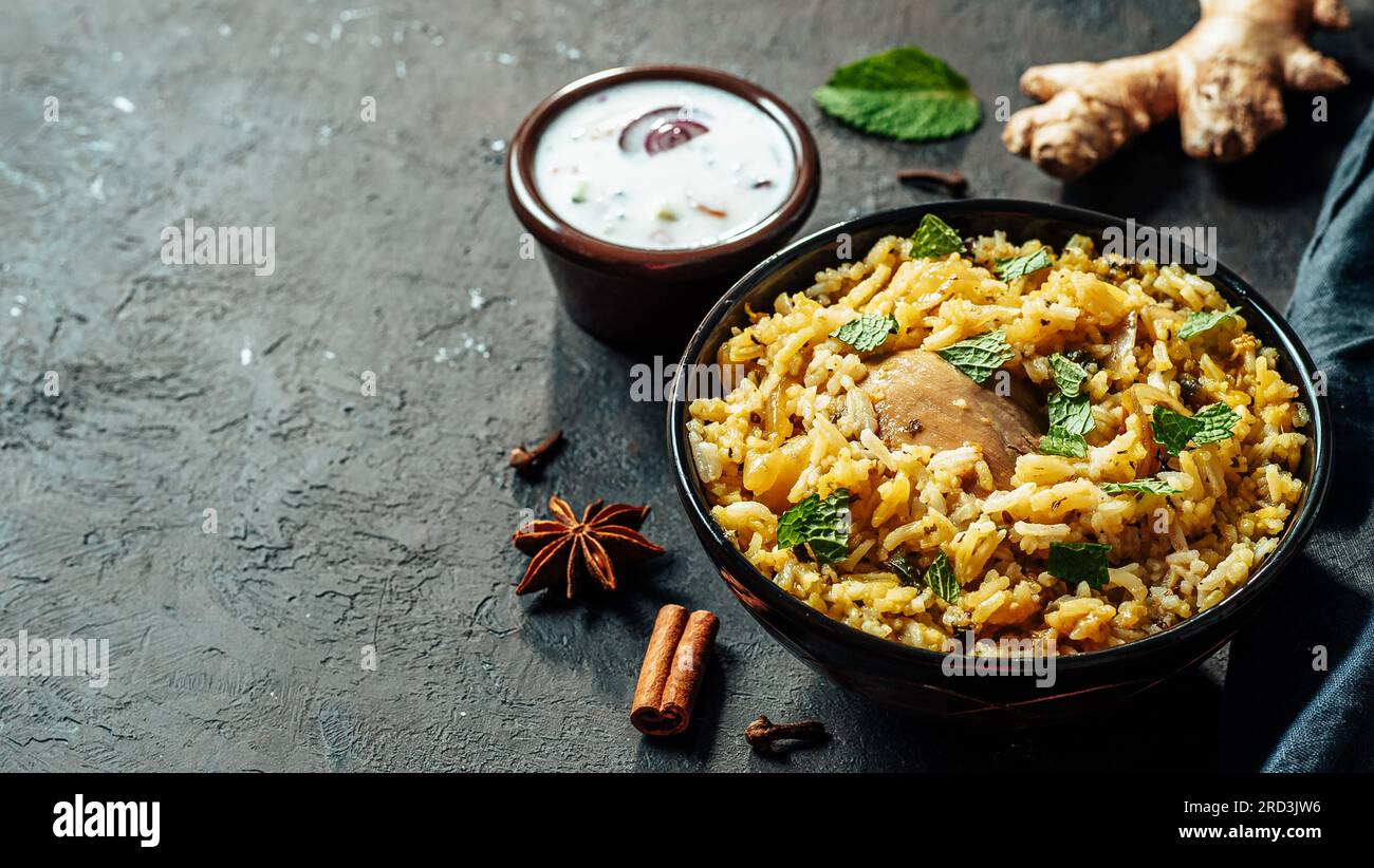 Pakistani food - biryani rice with chicken and raita yoghurt dip ...
