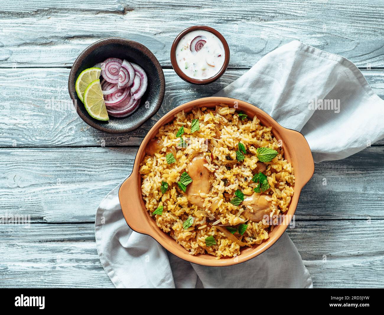 Pakistani food - biryani rice with chicken and raita yoghurt dip ...