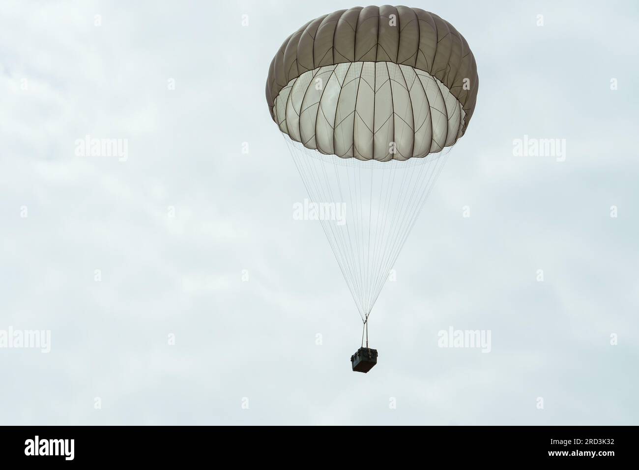 A re-supply bundle is airdropped from a Latvian AN-2 aircraft over a ...