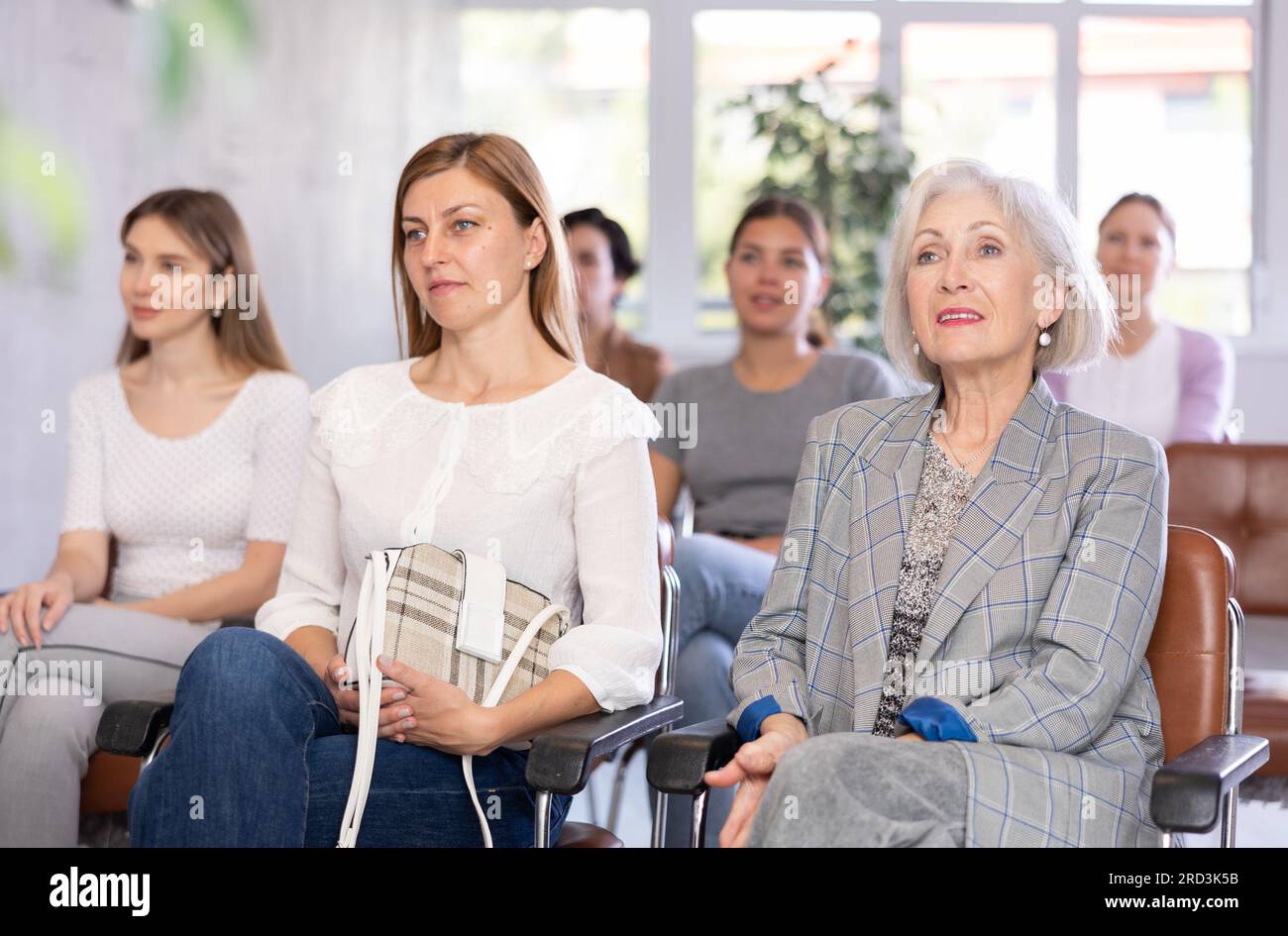 Interested women of different ages listening to master class Stock ...