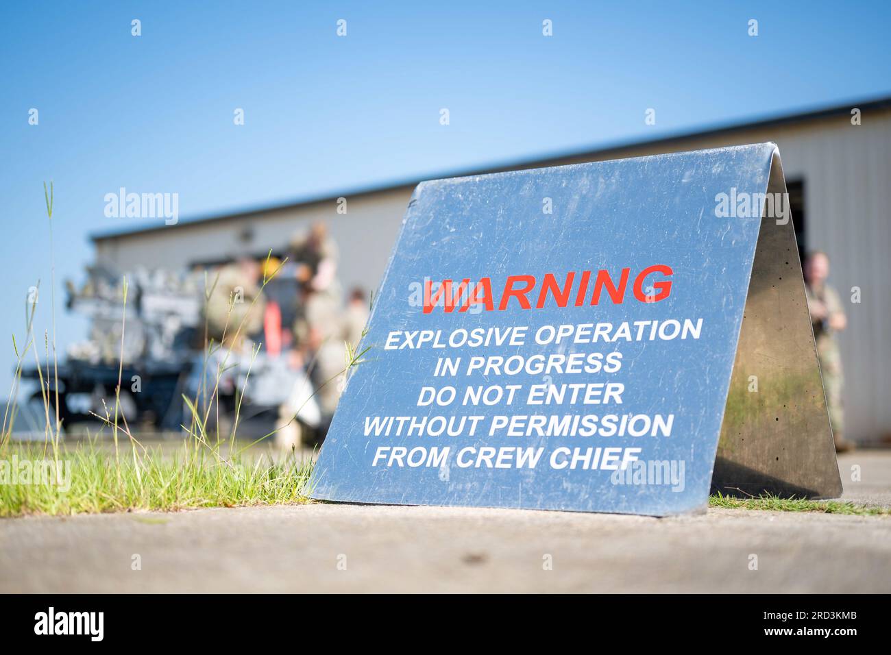 An explosive operation warning sign is placed on the perimeter of a ...