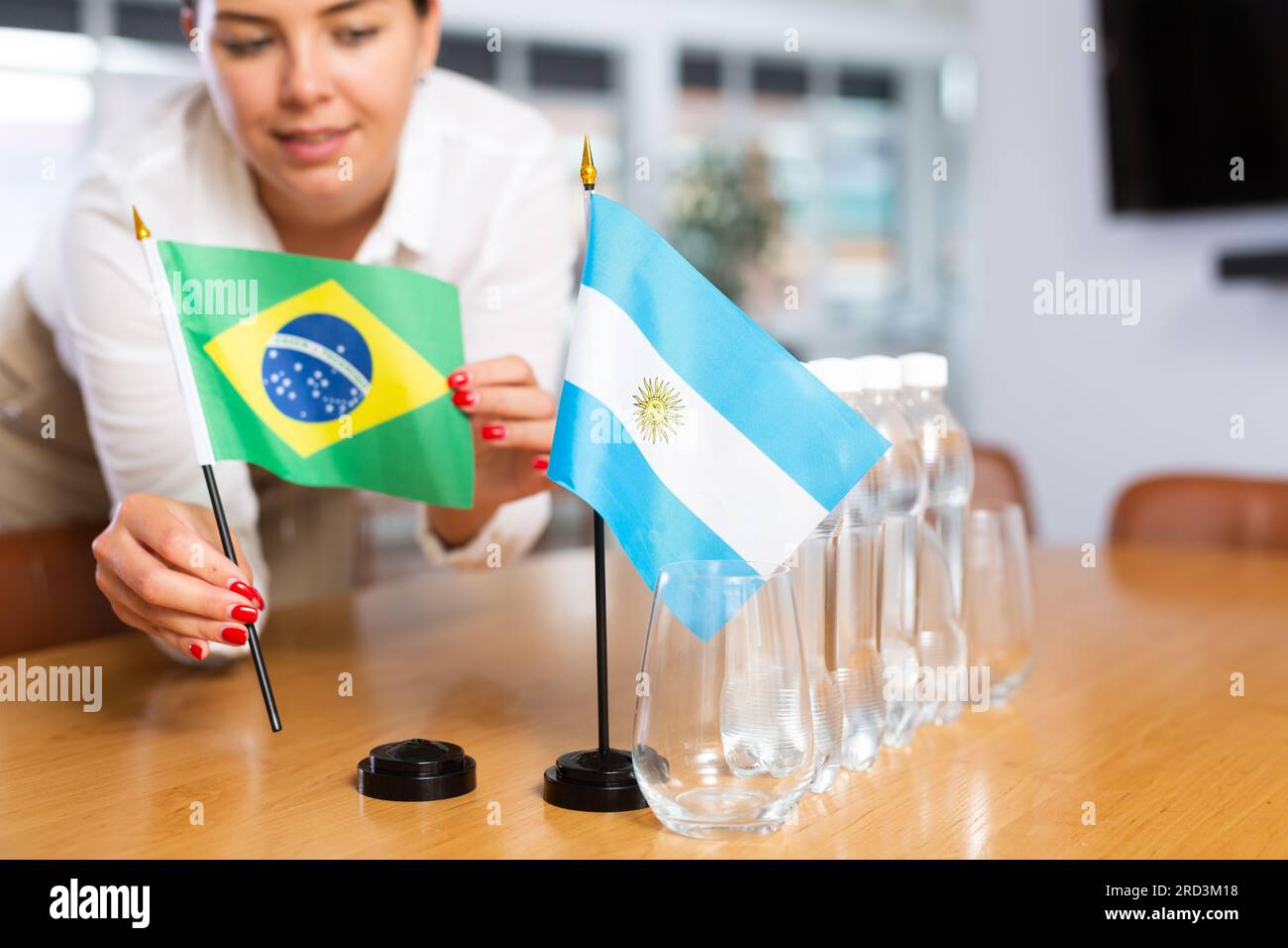 Unrecognizable girl sets midget flags of Argentina and Brazil before ...