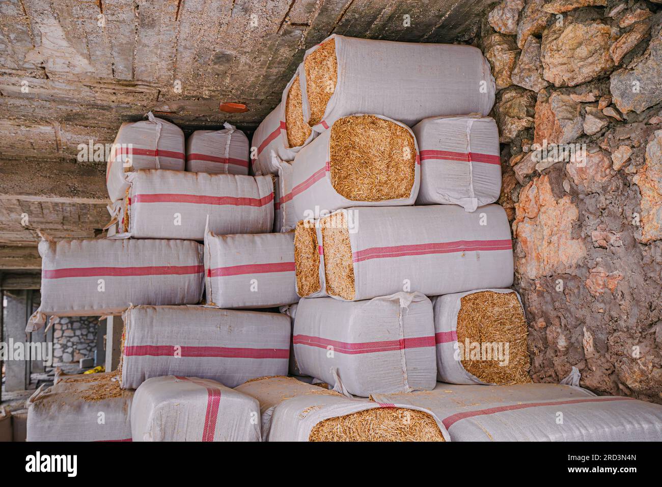 organized stacks of packed hay in a barn, carefully prepared to provide ...