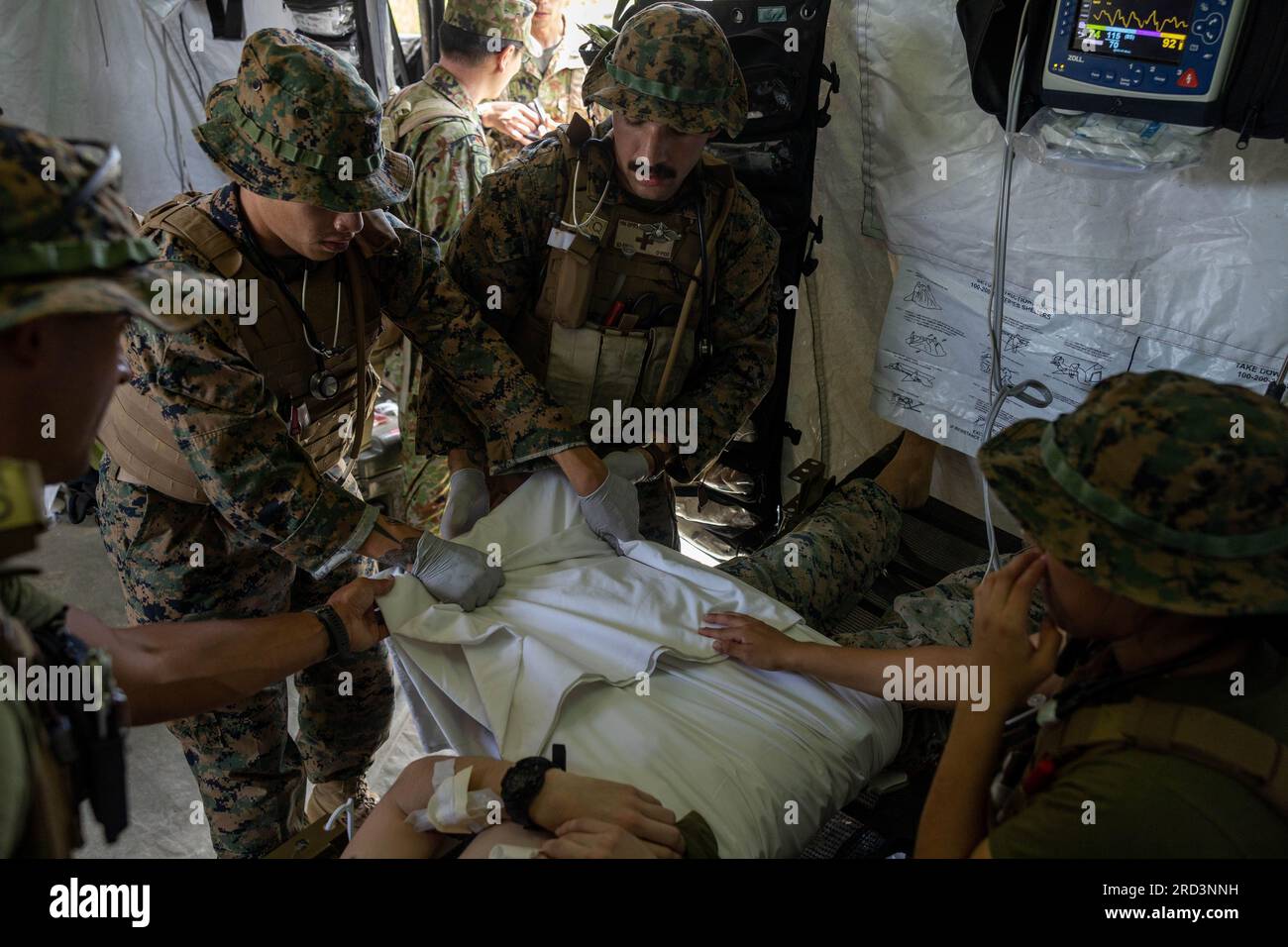 U.S. Navy Corpsmen with 3rd Marine Logistics Group apply a hip girder ...