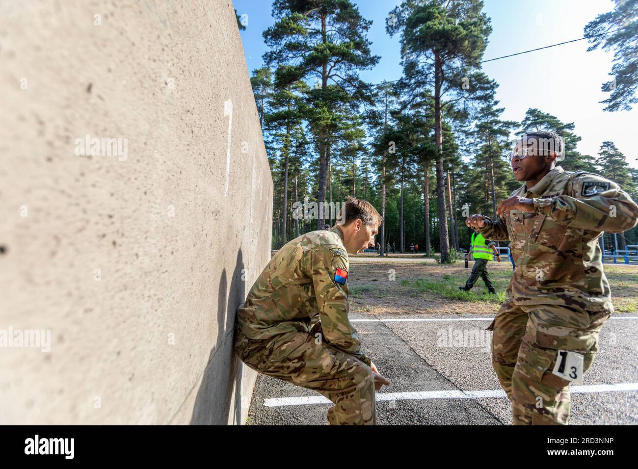 British Lt. Col. Matthias Blaschke, left, assists U.S. Army Reserve Sgt ...