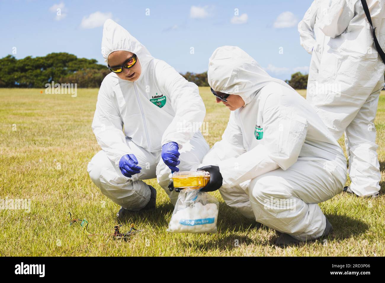 Agents with the Federal Bureau of Investigation take samples of ...