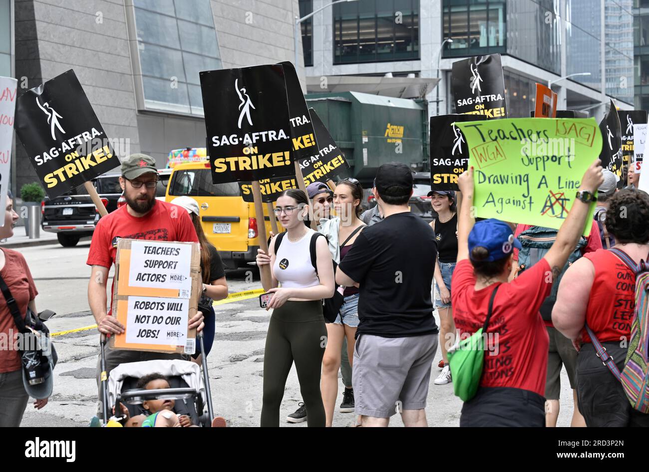 Picketers carry signs outside Amazon and HBO studios on Tuesday, July ...