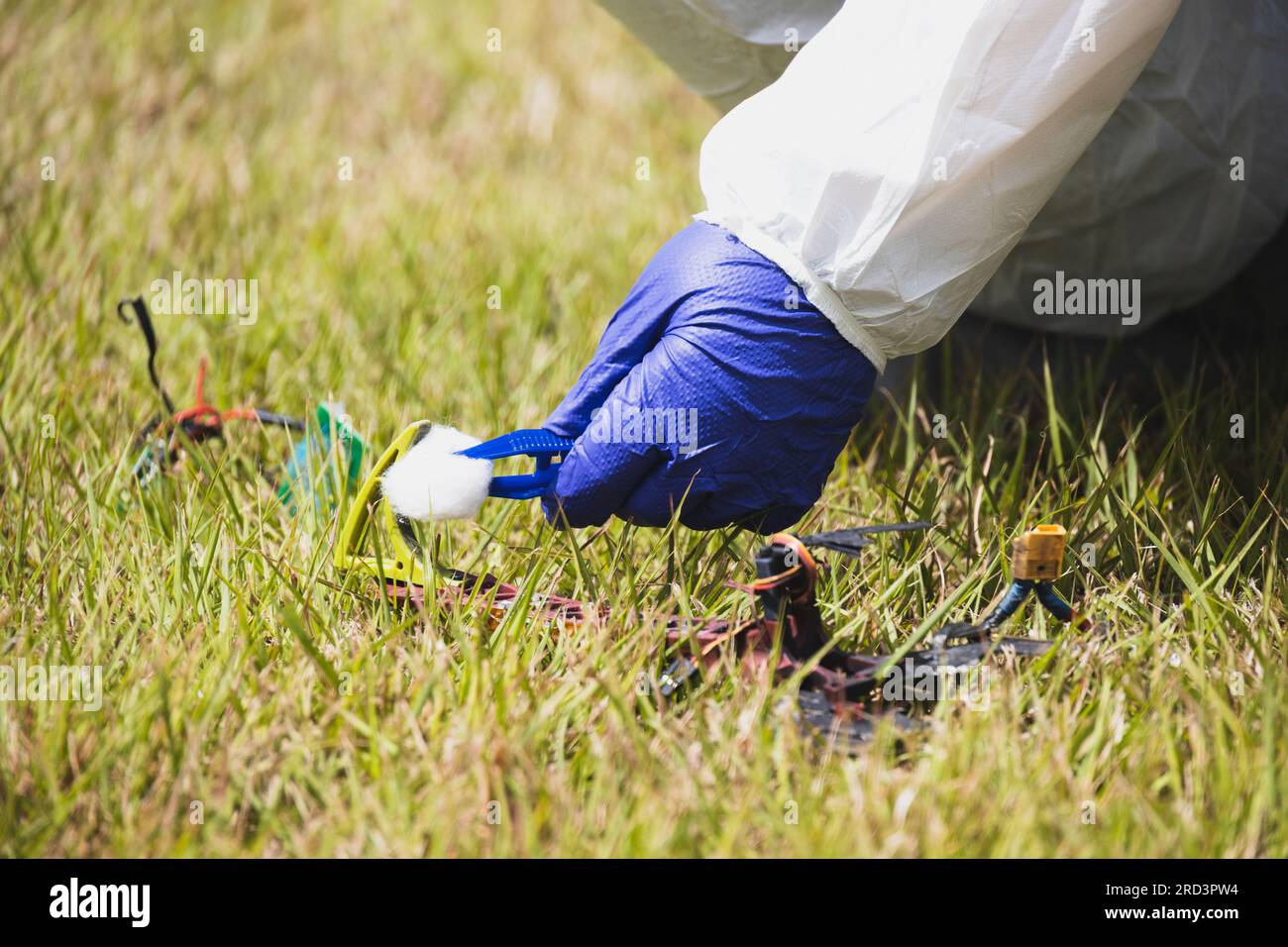 An agent with the Federal Bureau of Investigation takes samples of ...