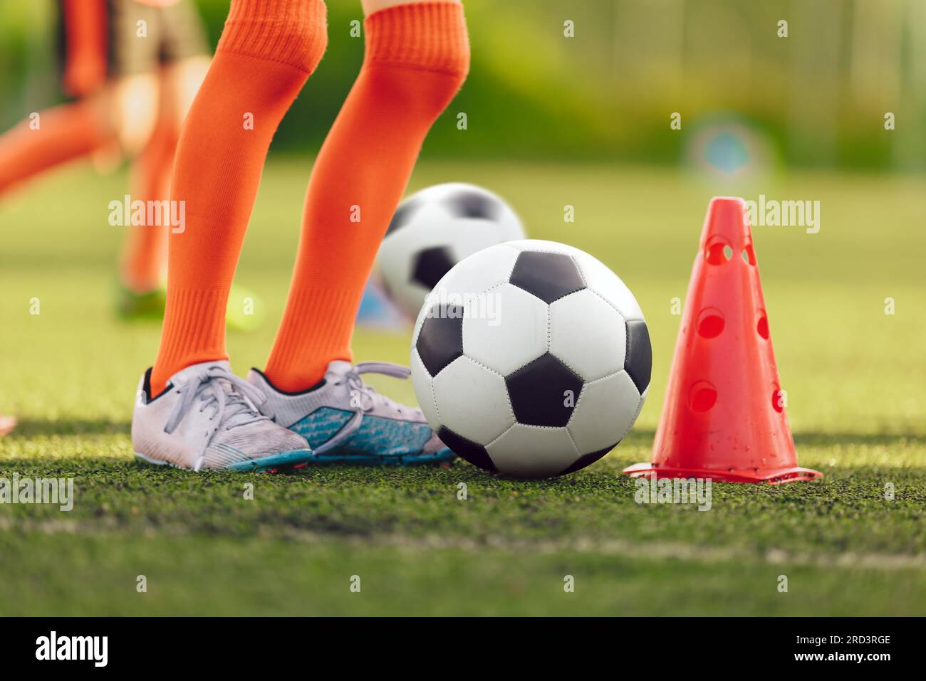 Legs of youth soccer player on training drill. Football summer training ...