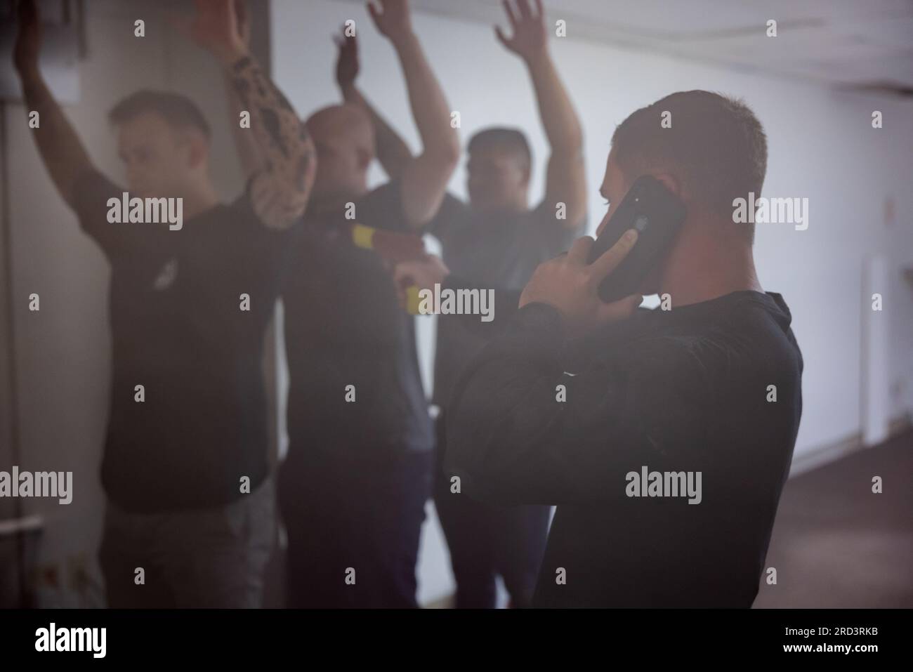 A simulated active shooter instructs simulated hostages while talking ...