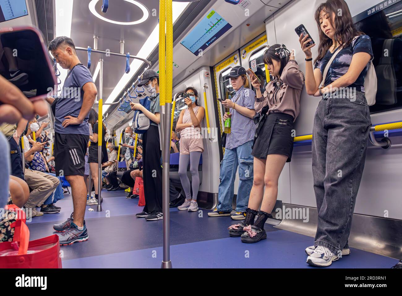 Passengers on MTR rapid transit train, Hong Kong, SAR, China Stock Photo - Alamy