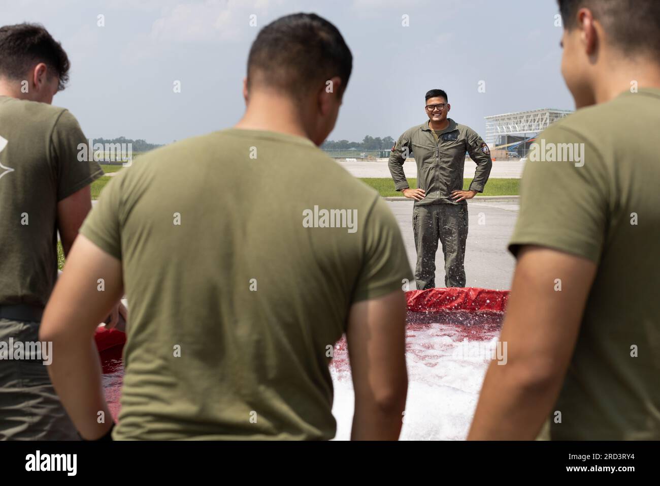 U.S. Marine Corps Sgt. Amiel D. Roxas, center right, station captain ...