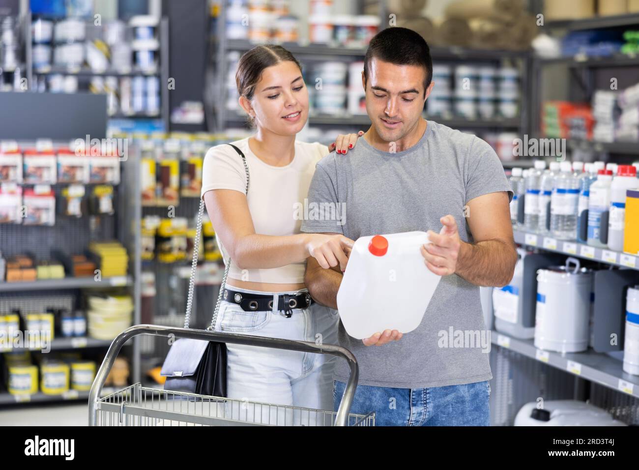Husband and wife choose plastic canister together in hardware ...