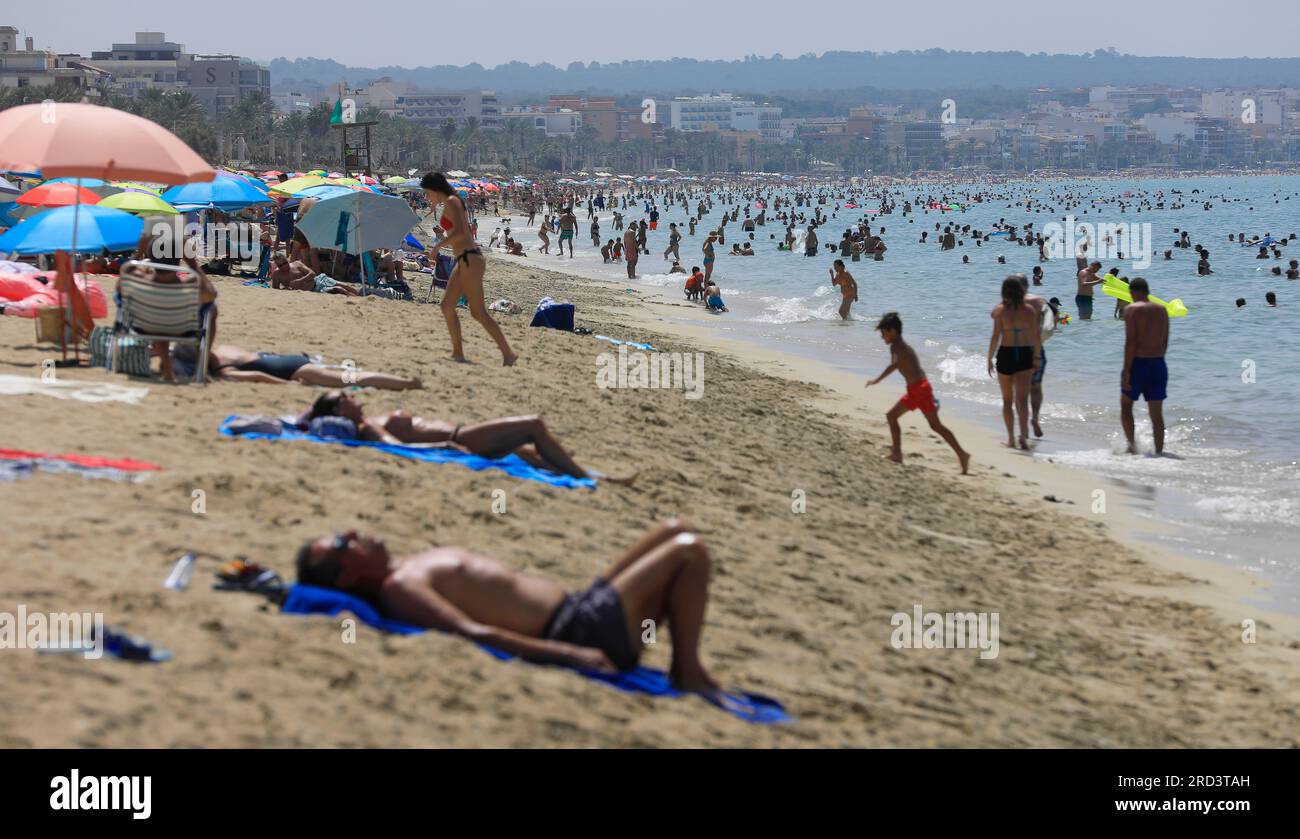 Palma De Mallorca, Spain. 18th July, 2023. People swim and sunbathe in hot temperatures on the ...