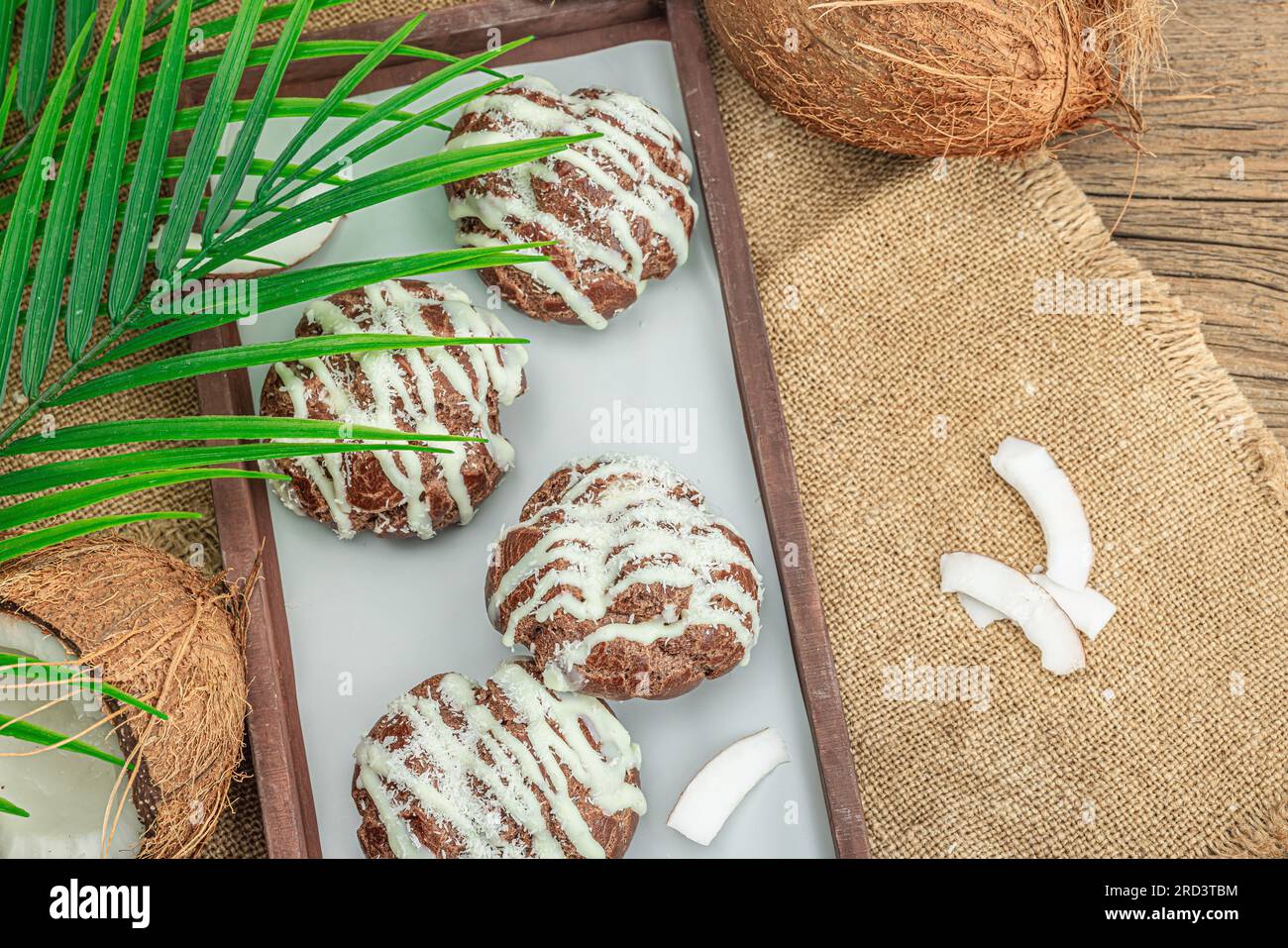 Profiteroles choux pastry buns with coconut cream served in tropical ...