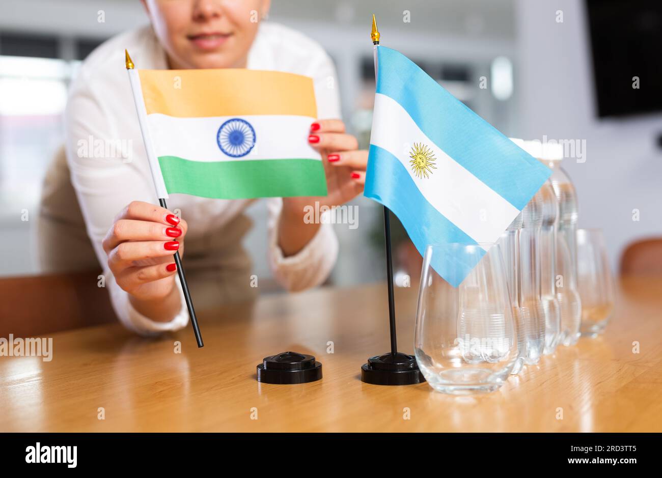 Unrecognizable girl sets midget flags of Argentina and India before ...