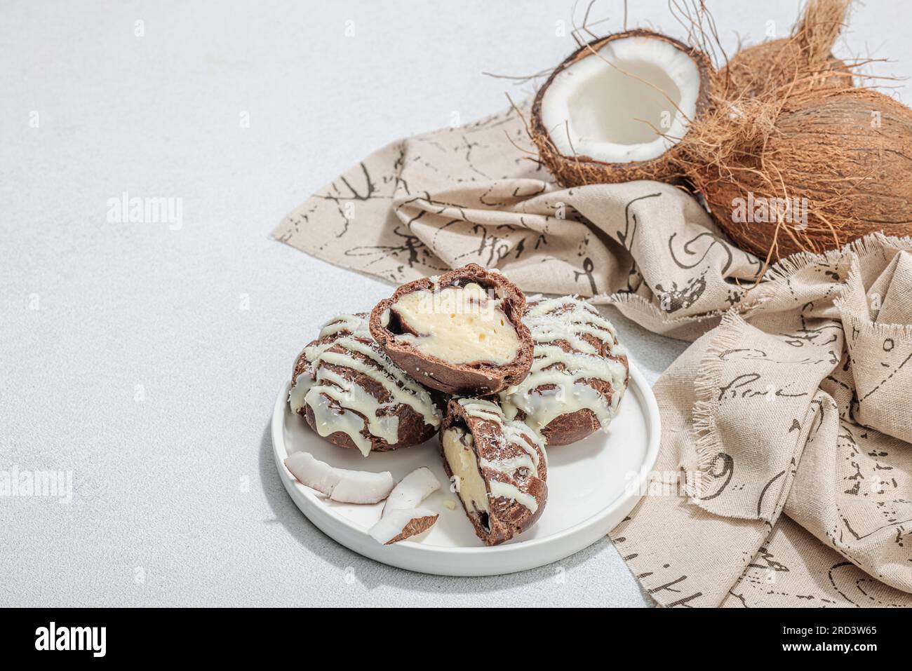 Profiteroles choux pastry buns with coconut cream served in tropical ...