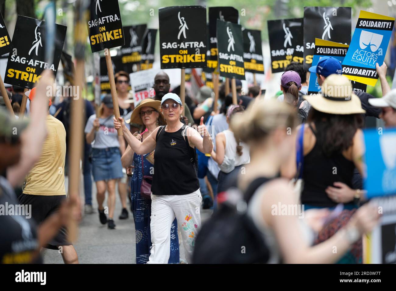 Picketers carry signs outside NBC in Rockefeller Center on Tuesday ...