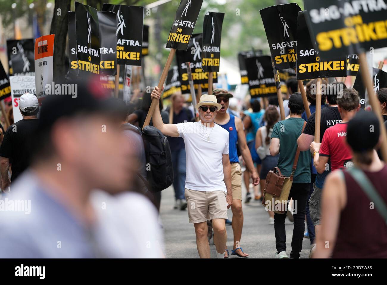 Picketers carry signs outside NBC in Rockefeller Center on Tuesday ...