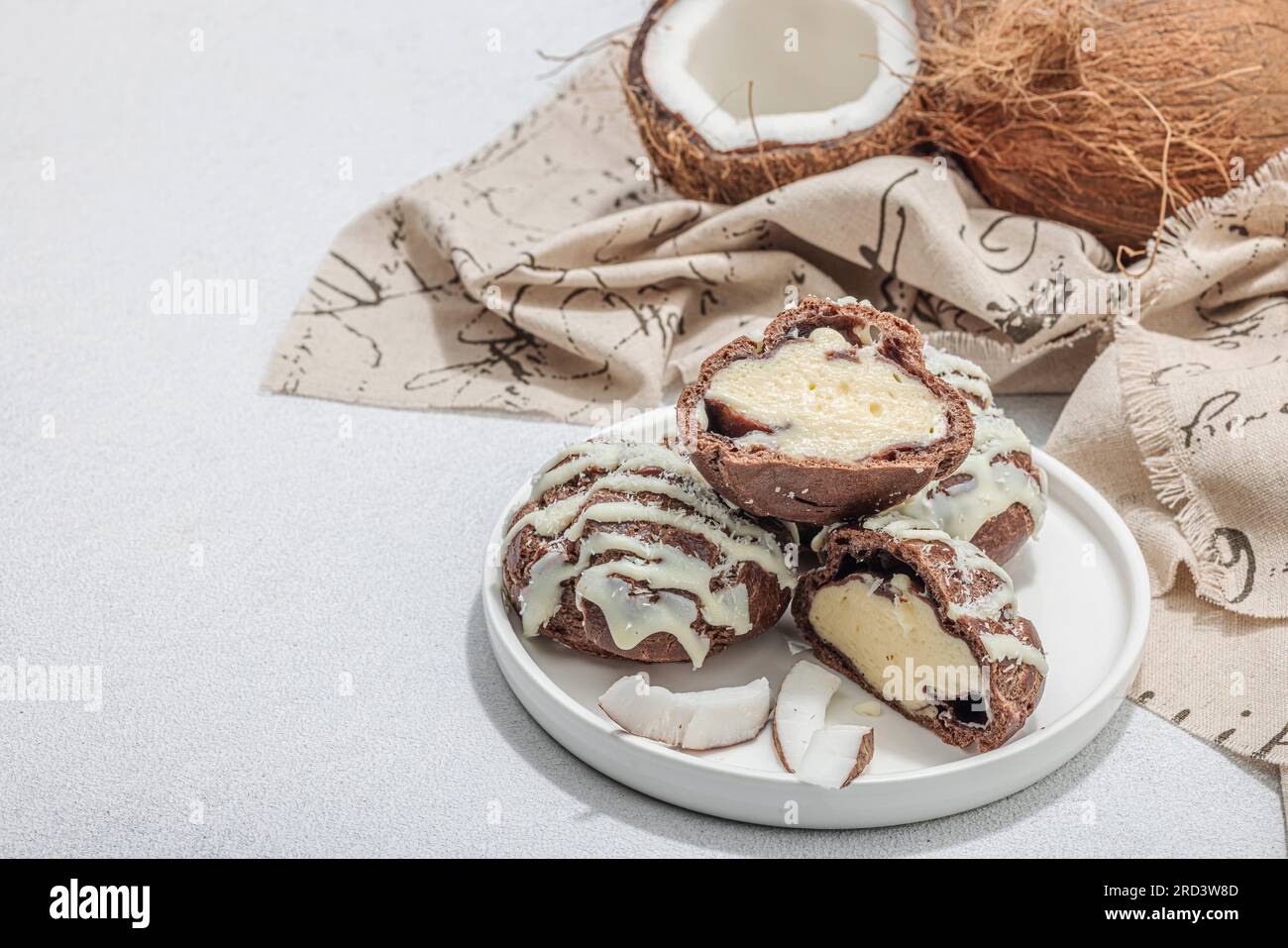 Profiteroles choux pastry buns with coconut cream served in tropical ...