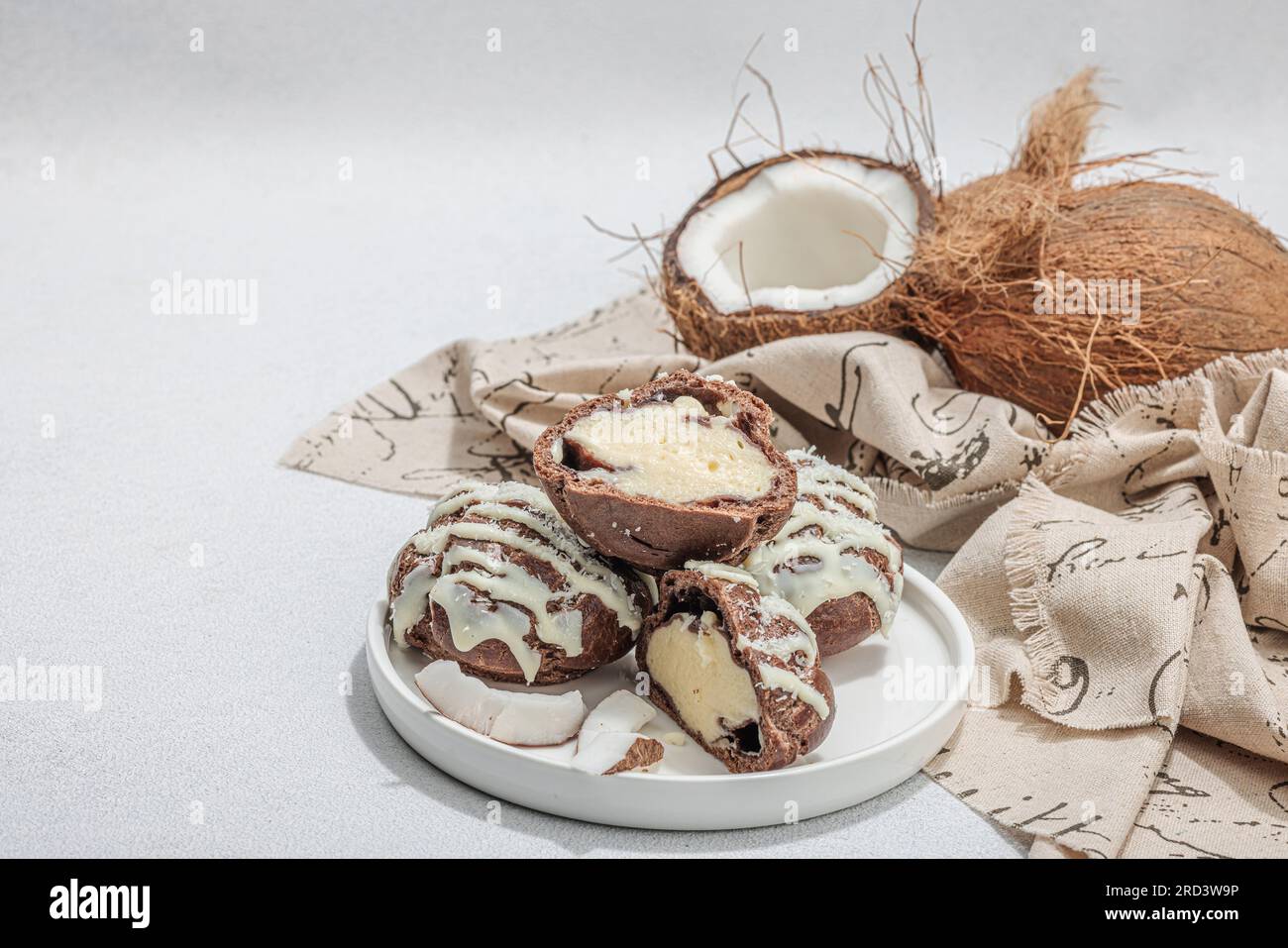 Profiteroles choux pastry buns with coconut cream served in tropical ...