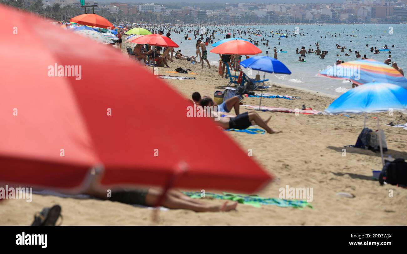 Palma De Mallorca, Spain. 18th July, 2023. People swim and sunbathe in hot temperatures on the ...
