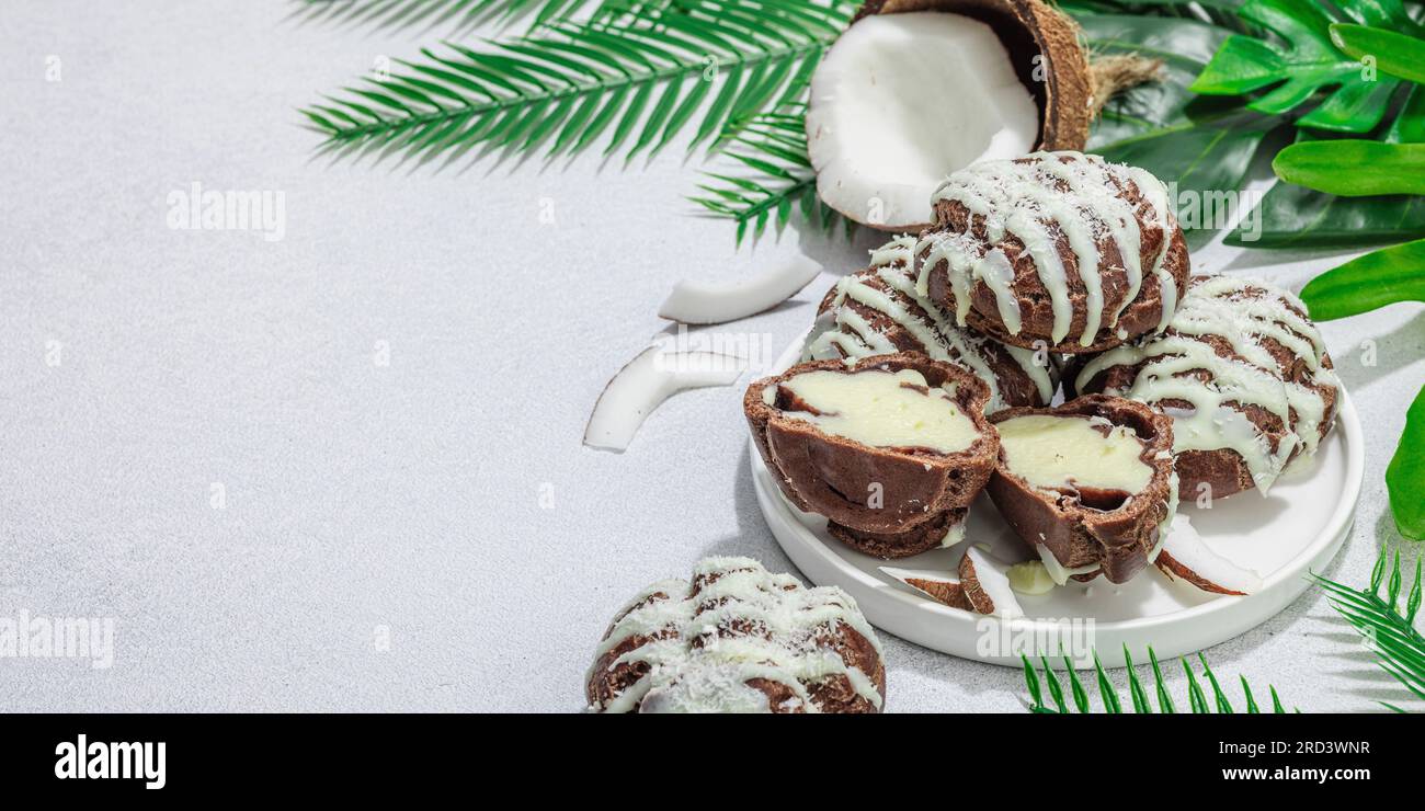 Profiteroles choux pastry buns with coconut cream served in tropical ...