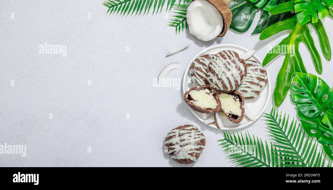 Profiteroles choux pastry buns with coconut cream served in tropical ...