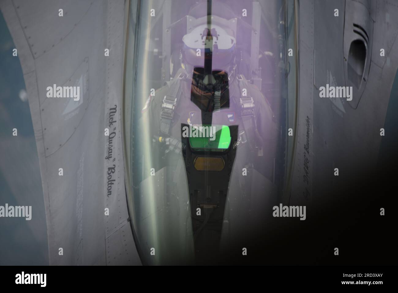 The refueling boom from a KC-135 Stratotanker reflects across the ...