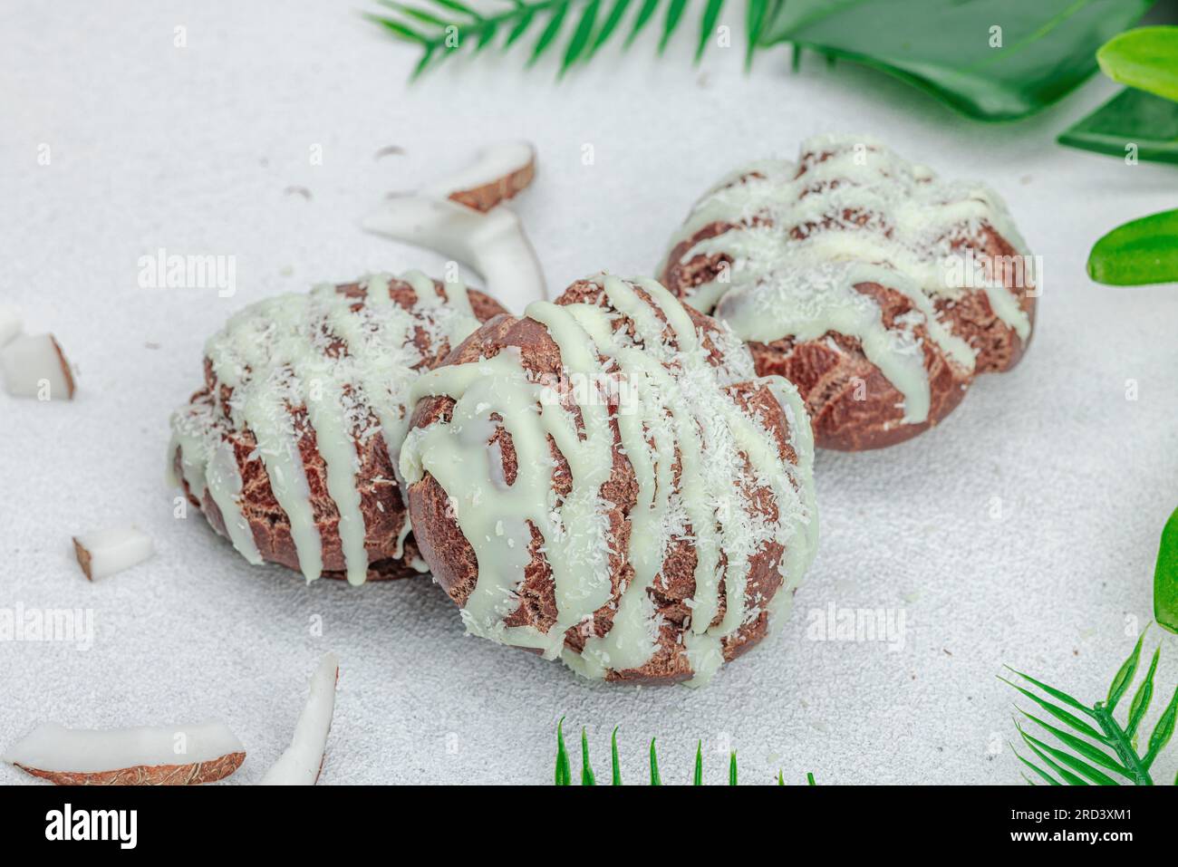 Profiteroles choux pastry buns with coconut cream served in tropical ...