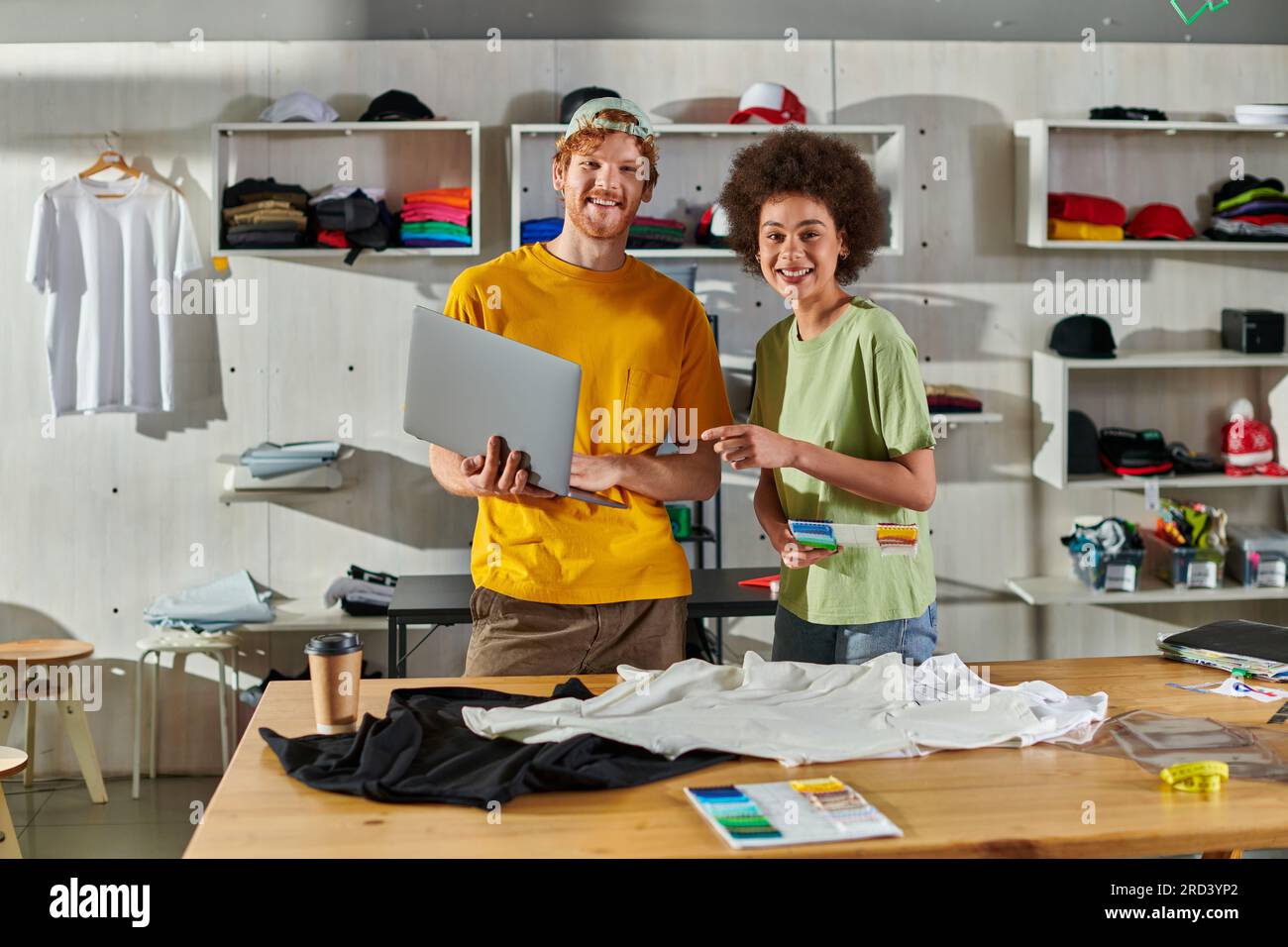 Positive young multiethnic craftspeople looking at camera while holding ...