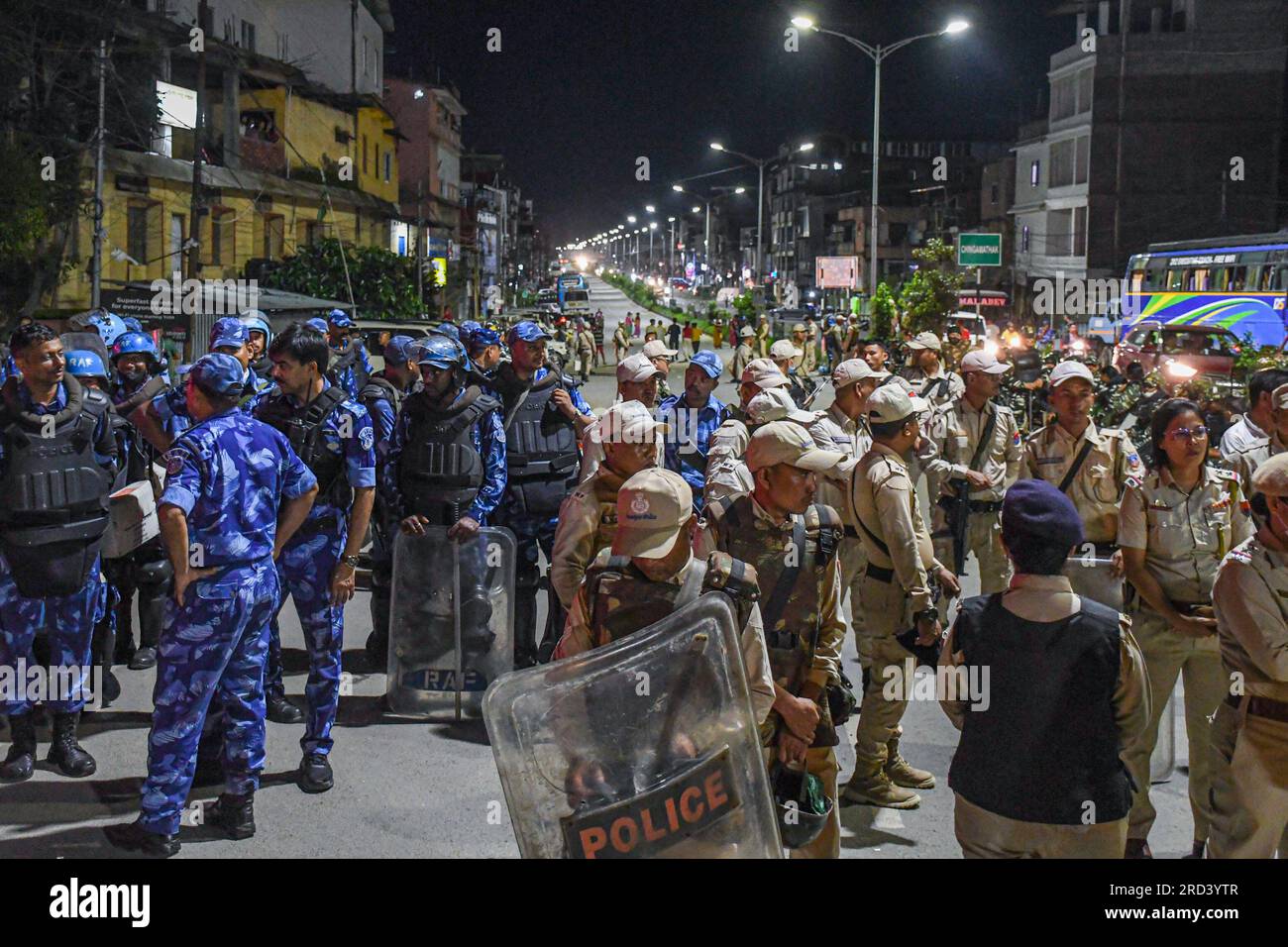 Rapid Action Force personnel (L) and Manipur policemen stand guard ...