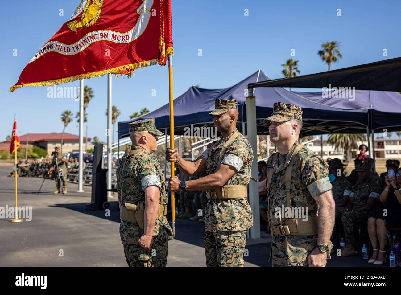 U.S. Marine Corps Col. Carlos Jackson, center, takes the colors to pass ...