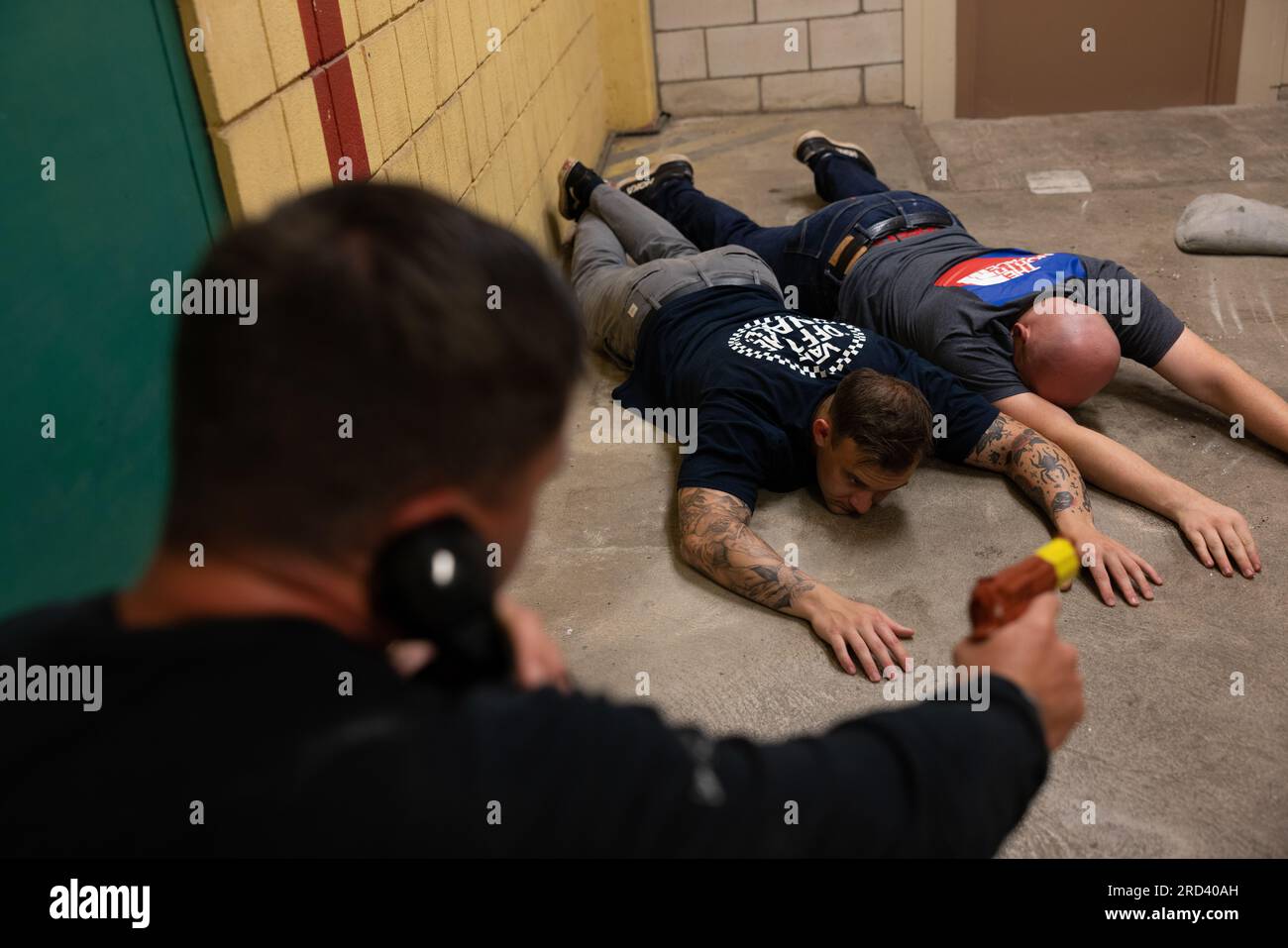 A simulated active shooter instructs simulated hostages while talking ...